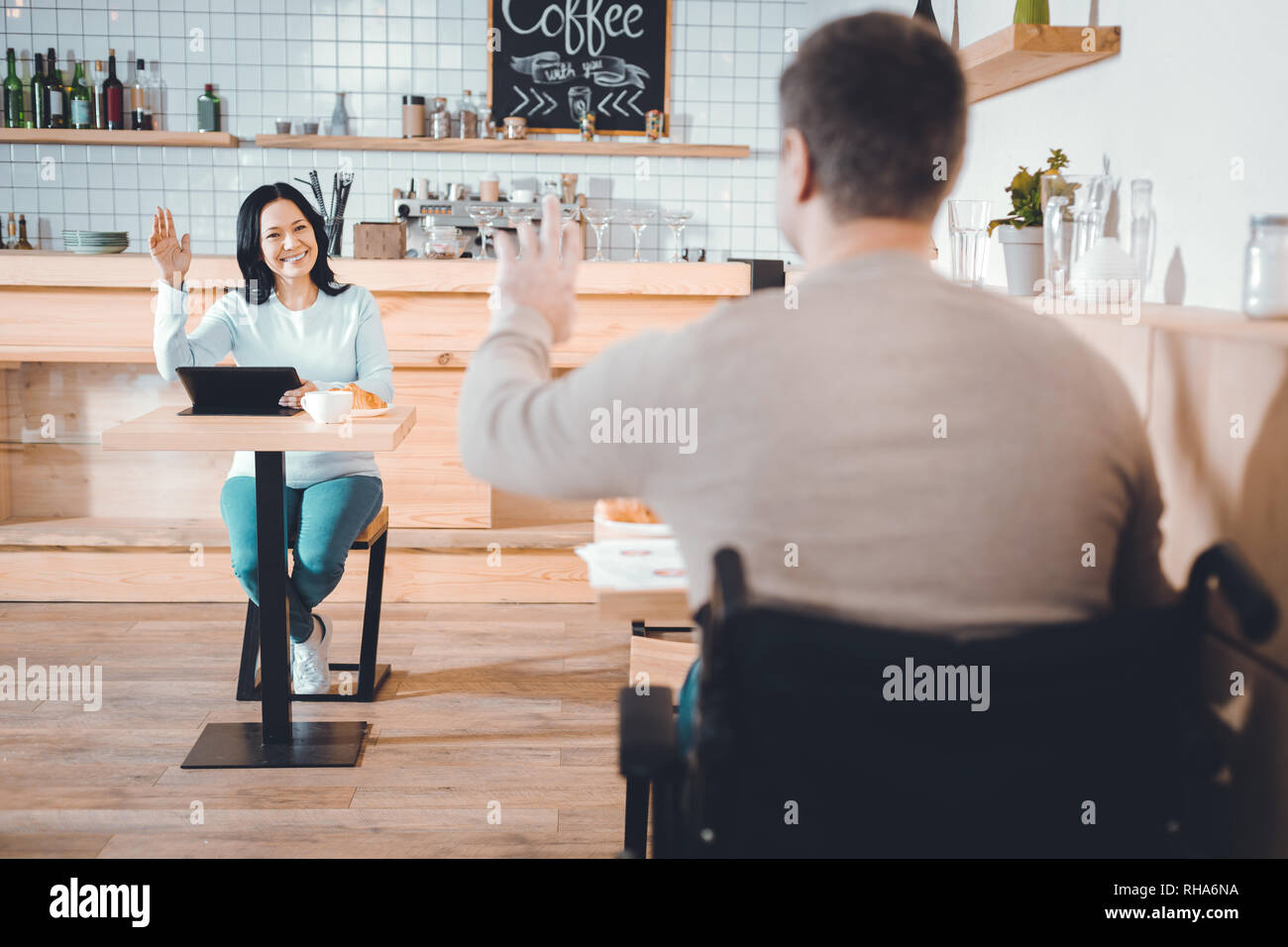 Happy friends meeting in a cafe Stock Photo - Alamy