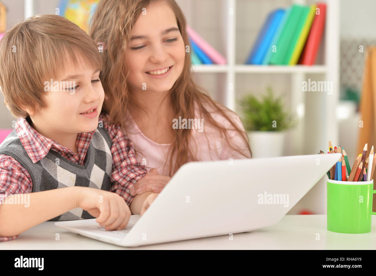 Portrait of Boy and girl using laptop Stock Photo - Alamy