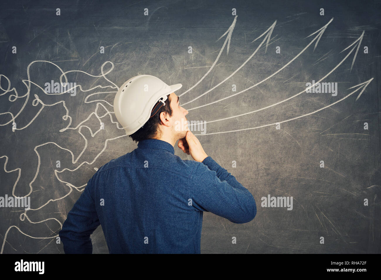 Rear view concentrated man engineer wearing protective helmet ...