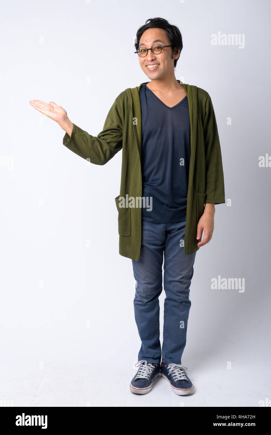 Full body shot of happy Japanese man showing something Stock Photo - Alamy