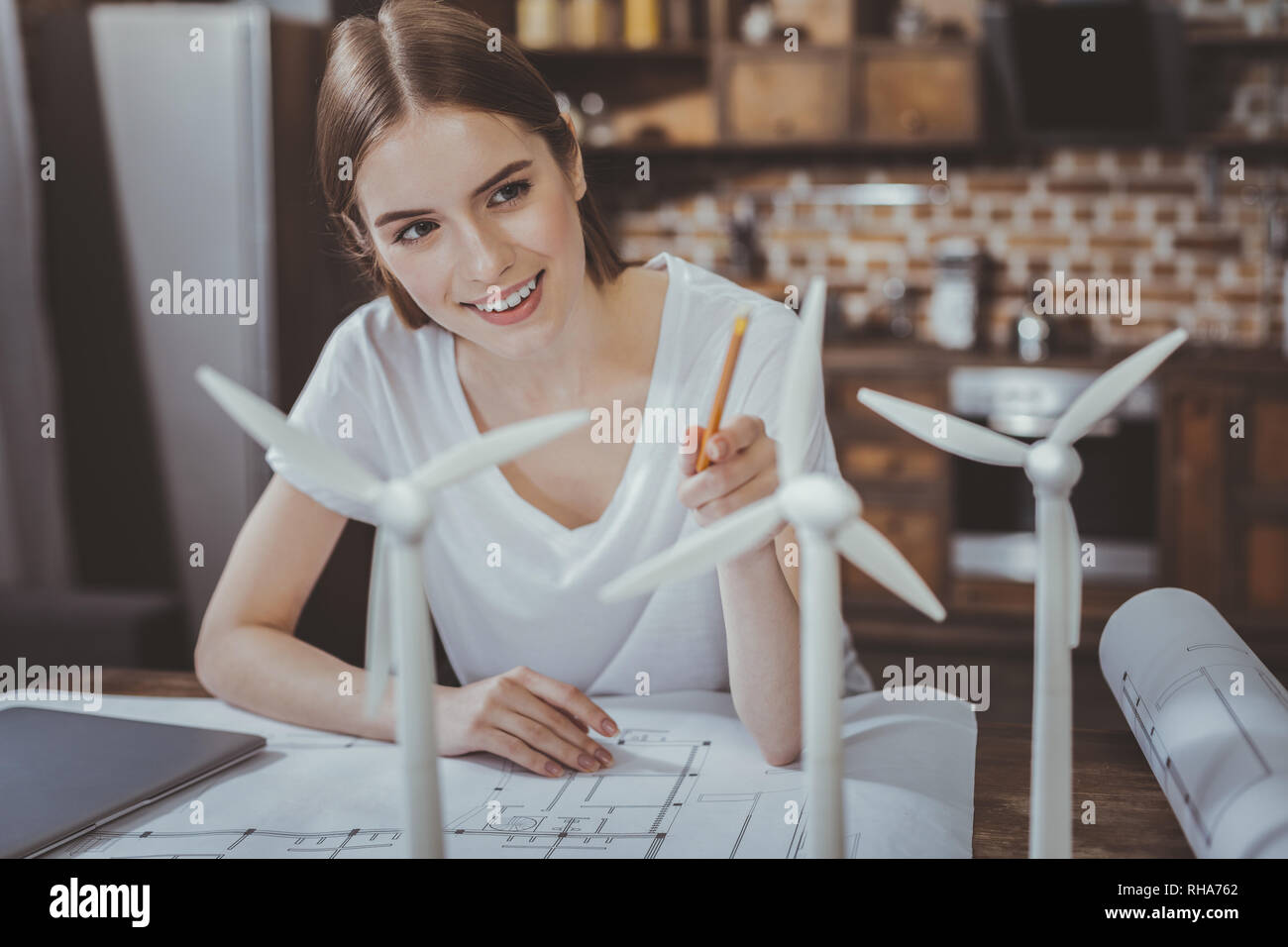 Positive delighted female person looking at models Stock Photo - Alamy