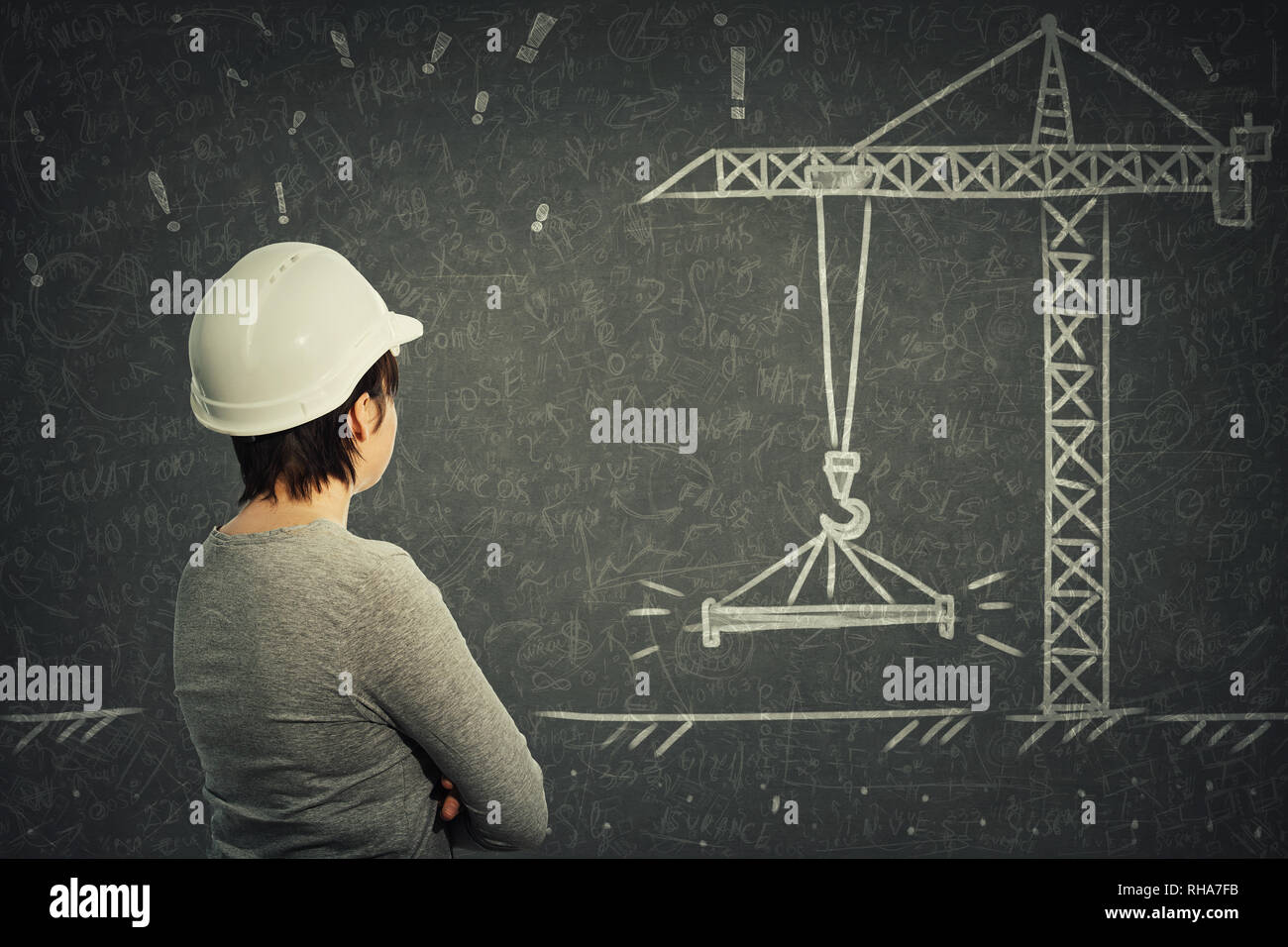 Rear view of confident young woman engineer wearing white protective ...