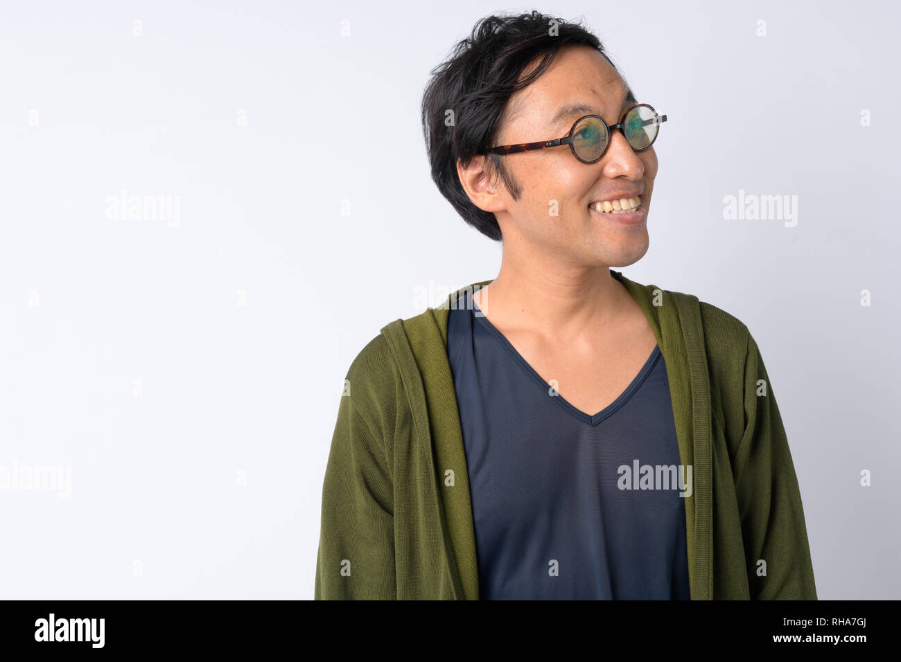 Portrait of happy Japanese man thinking against white background Stock ...