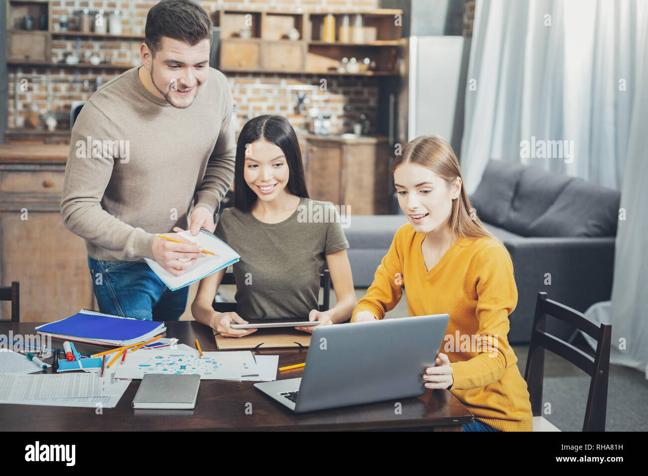 Charming three students exchanging knowledge Stock Photo - Alamy