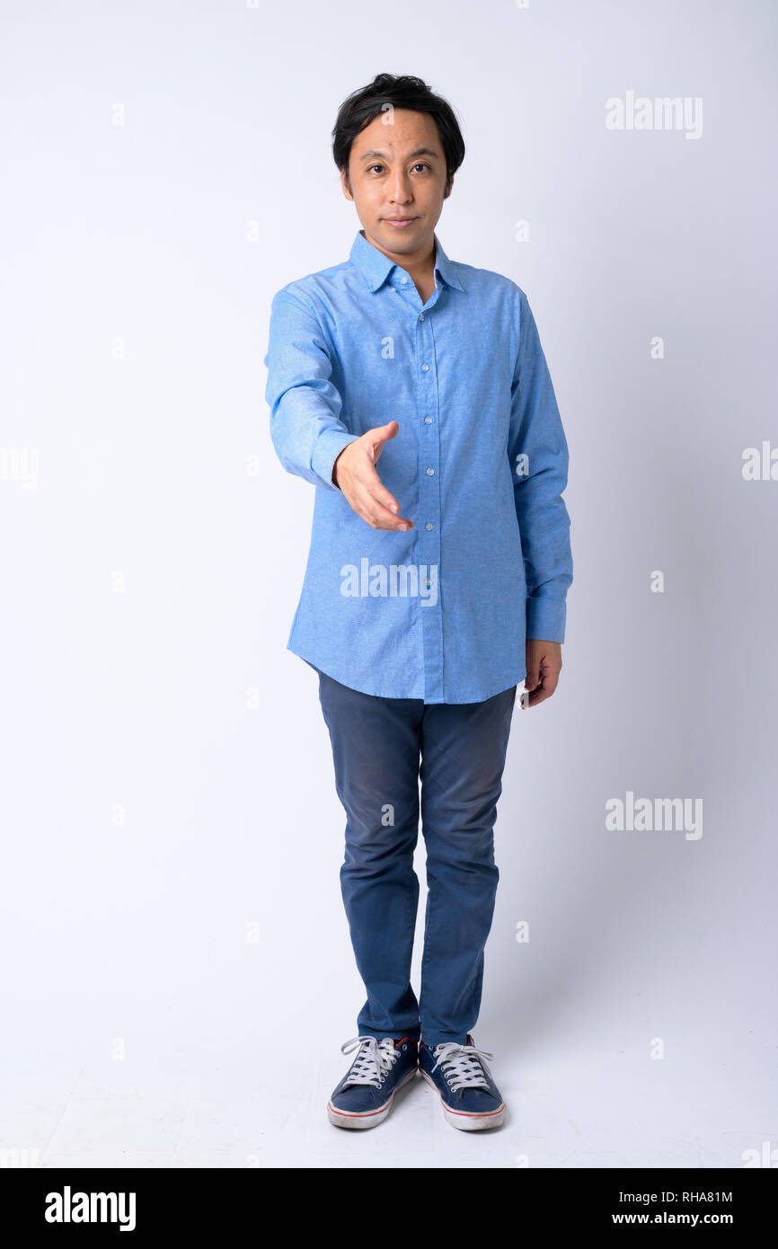 Full body shot of Japanese businessman giving handshake Stock Photo - Alamy