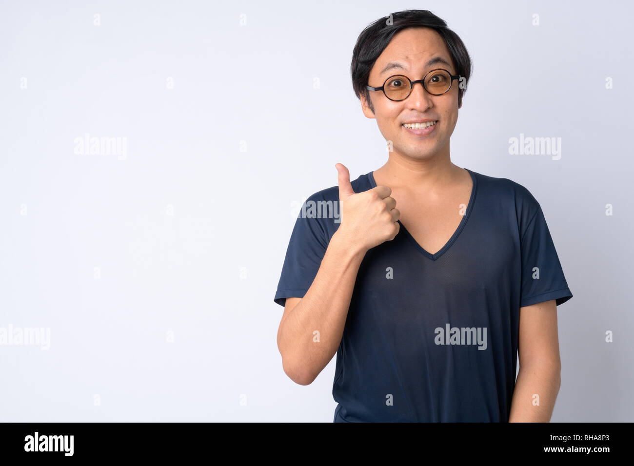 Portrait of happy Japanese man giving thumbs up Stock Photo - Alamy