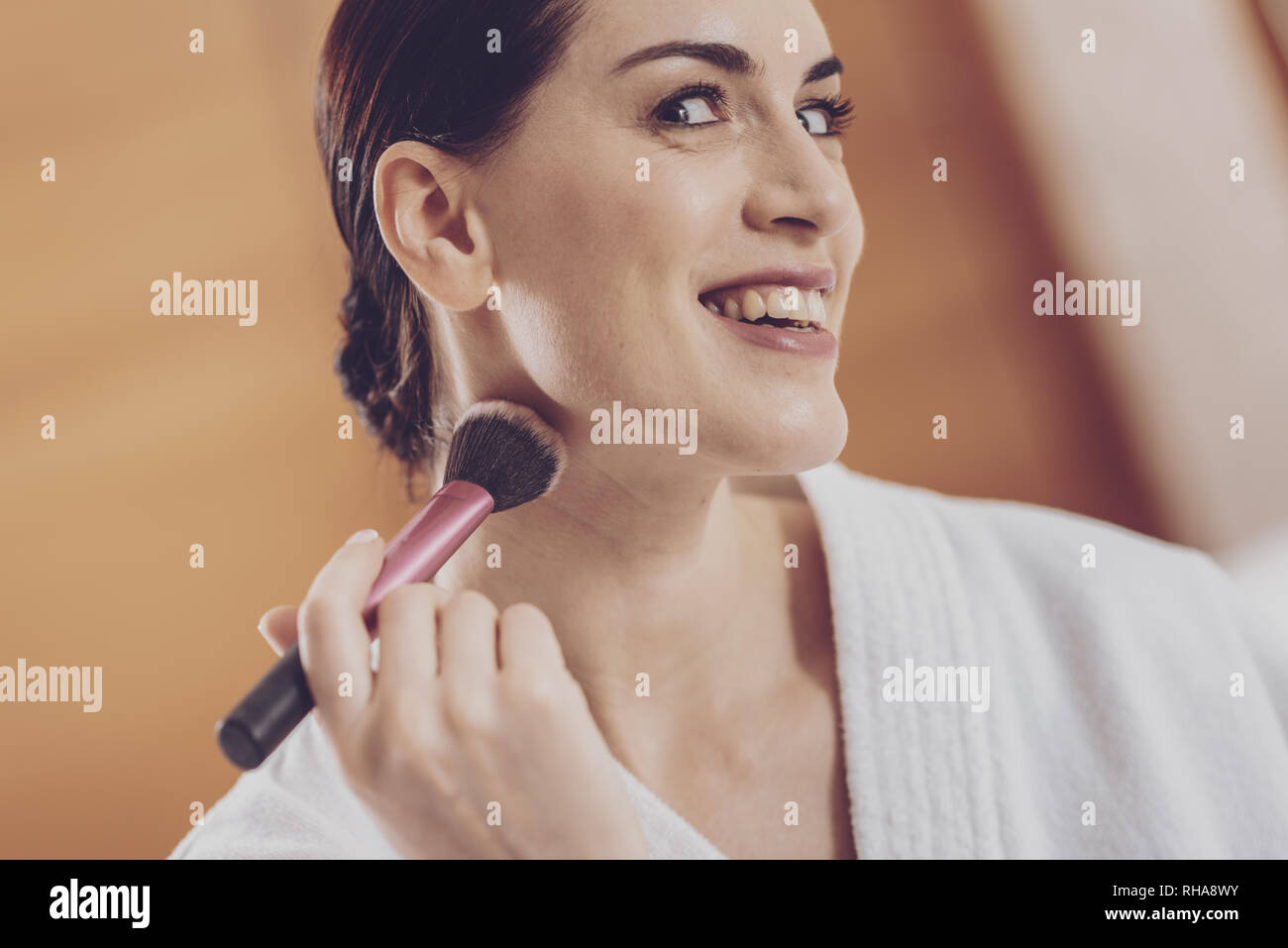 Attractive woman doing makeup Stock Photo - Alamy