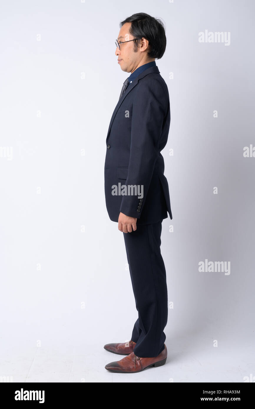 Full body shot profile view of Japanese businessman in suit Stock Photo ...