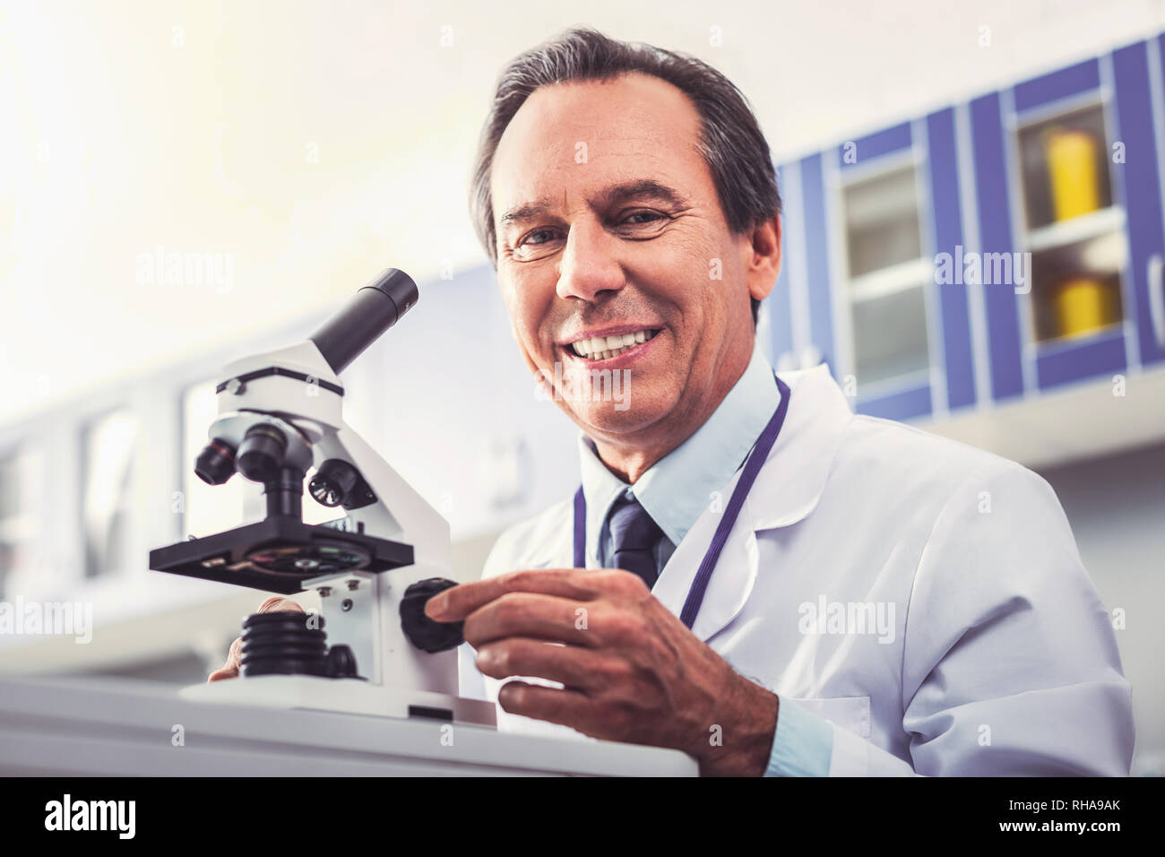 Researcher smiling while inventing new technology for microscope Stock ...