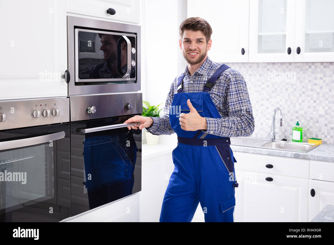 Close-up Of A Male Technician Standing In The Kitchen Showing Thumbs Up ...