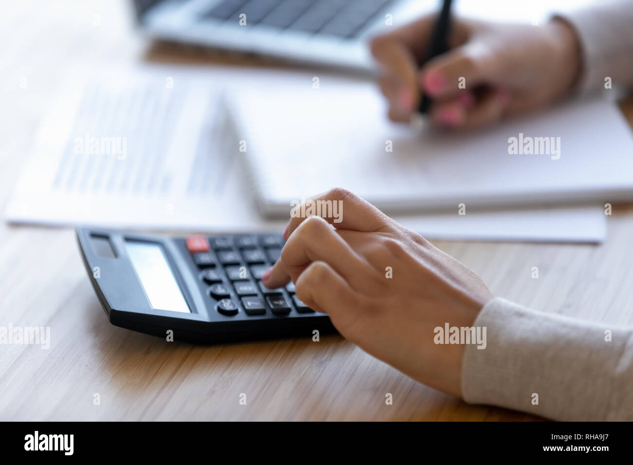 Female professional using calculator for business financial accounting ...