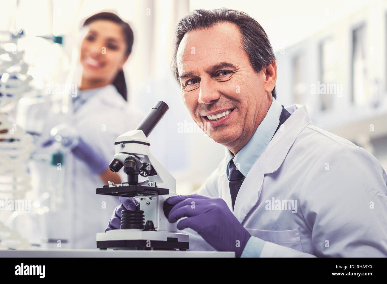 Smiling microbiologist making new discovery Stock Photo - Alamy