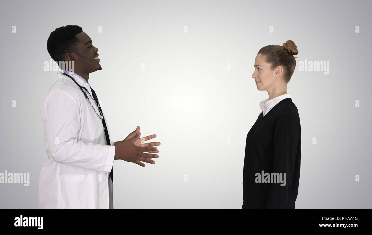 Doctor telling good news and patient leaves on gradient background ...