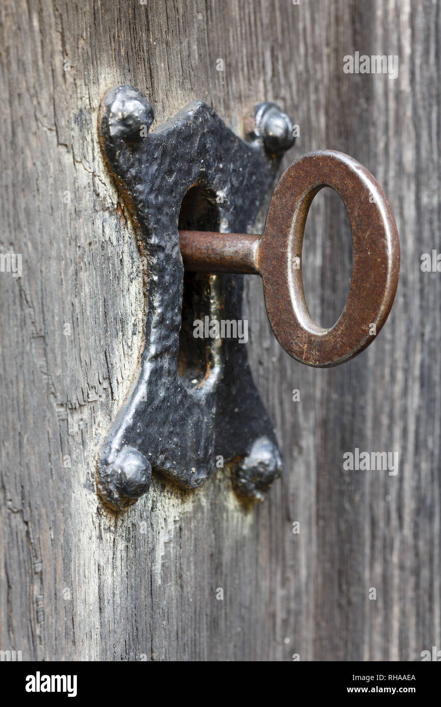 Old key in a keyhole. Illustrates concepts of security and encryption ...
