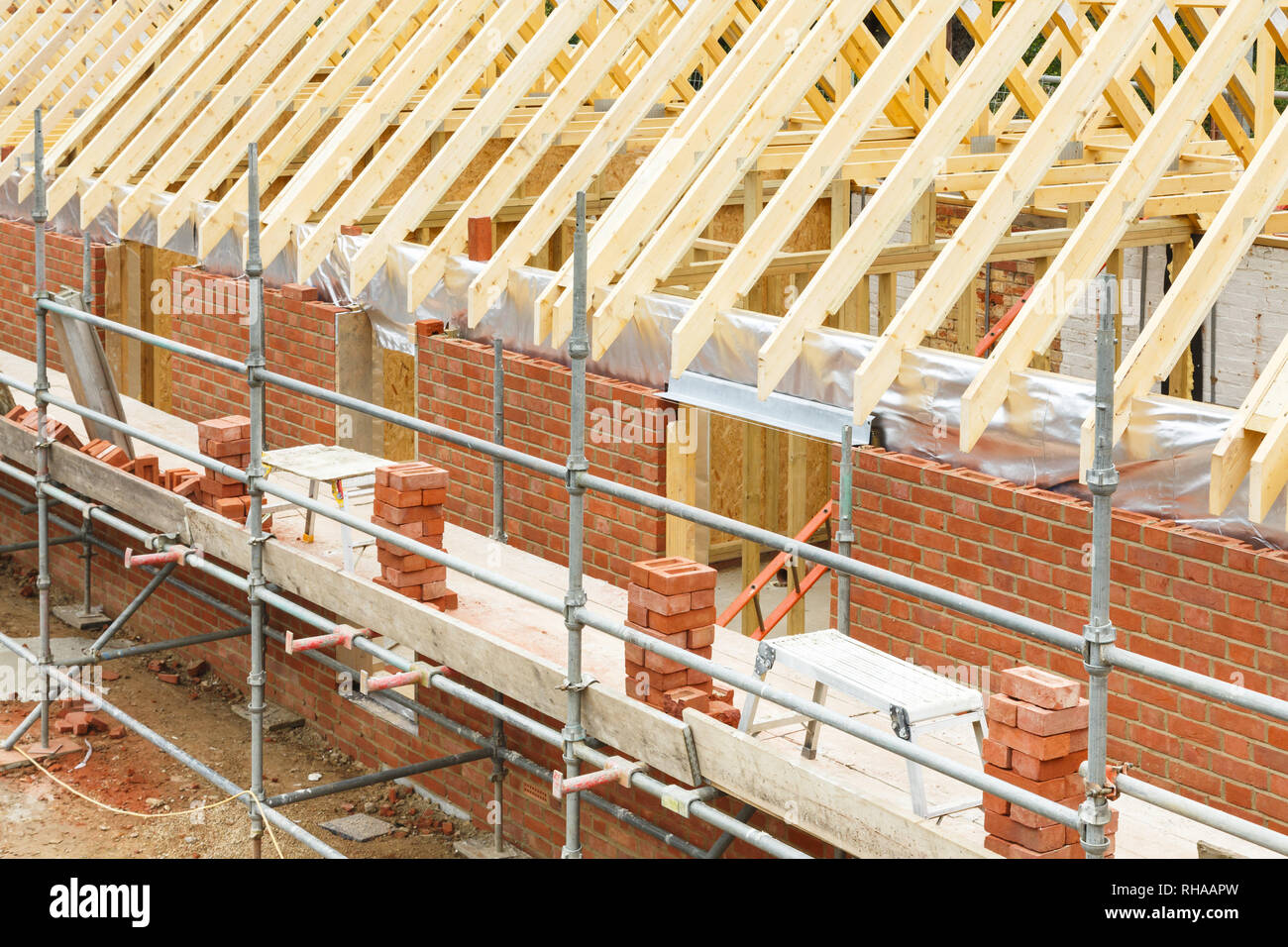 Construction site in UK with a house built from brick and timber ...