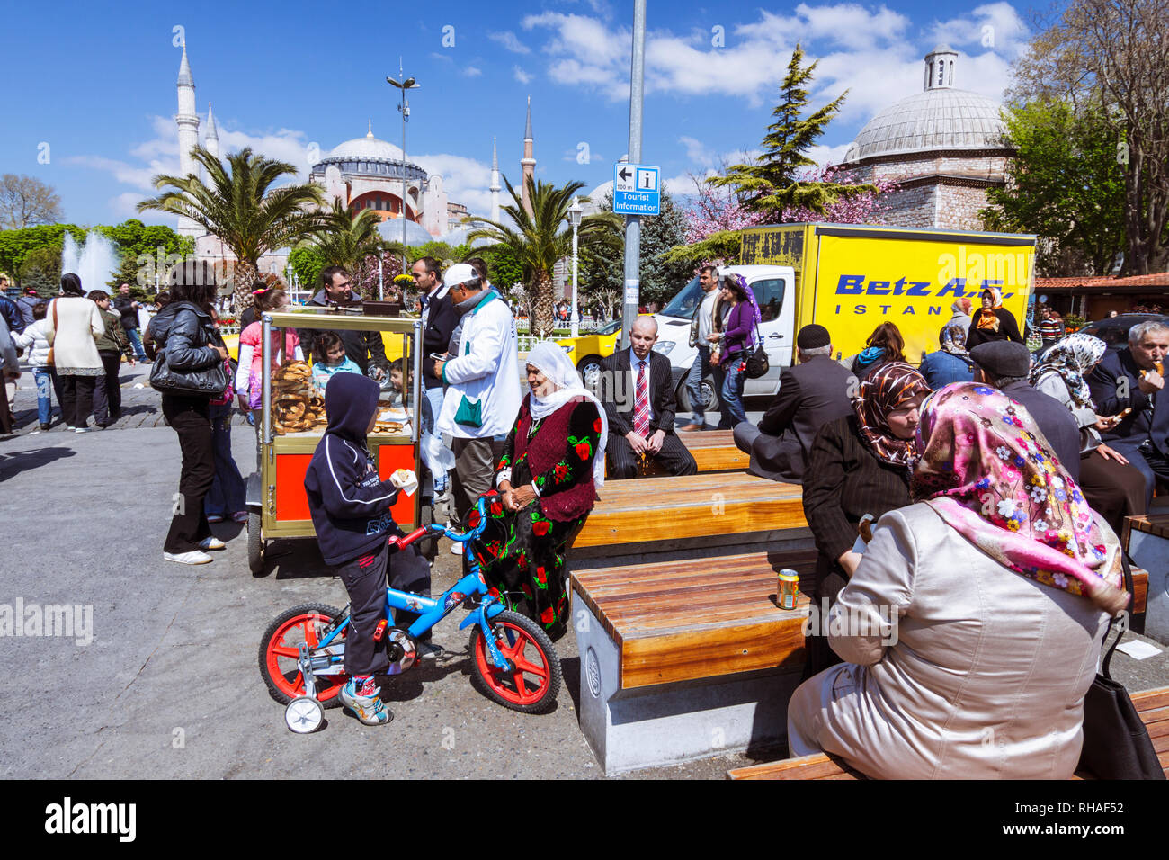 Istanbul, Turkey : People sit on Sultanahmet square with Hagia Sophia ...
