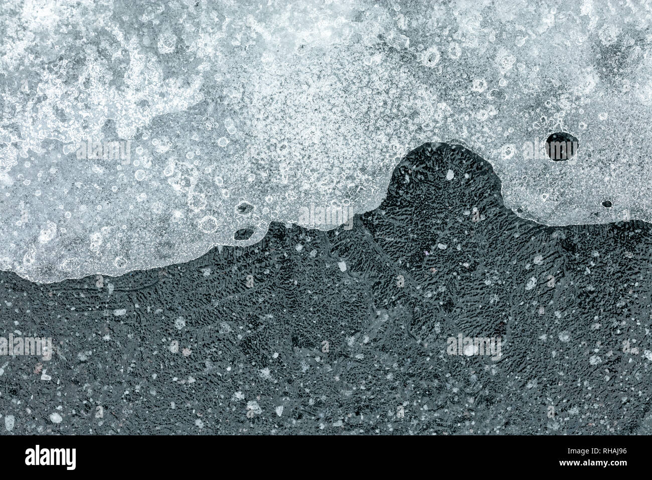 melting ice on frozen pavement surface. natural icy background Stock ...