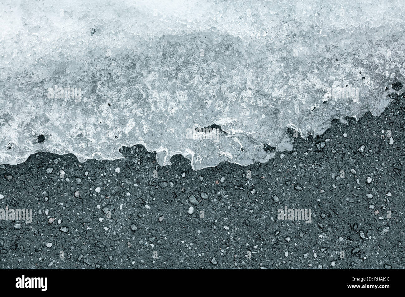 ice melting on pavement or black asphalt road in the spring Stock Photo ...