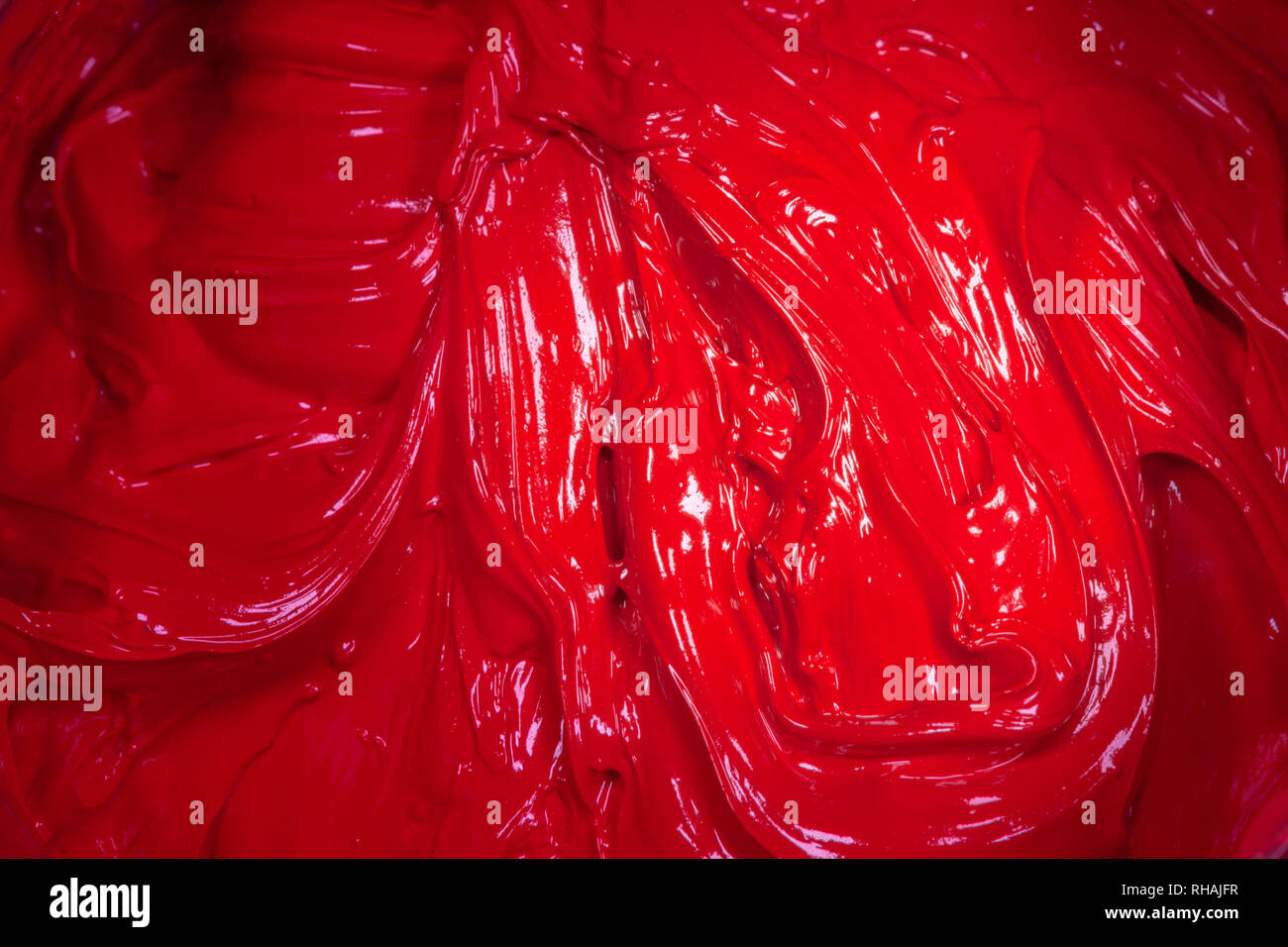 close up red color of oil paint. ink of screen printing for print on ...