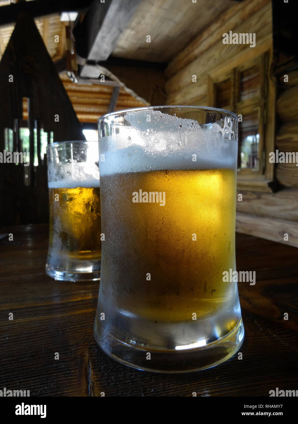 Two glasses of beer on the table at pub in country style Stock Photo ...