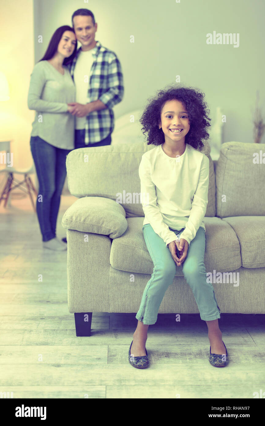 Affectionate parents hugging in the background looking at their ...