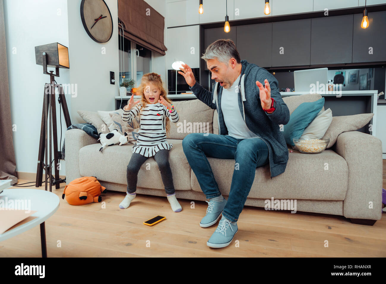 Pretty long-haired girl in a dress and her grey-haired father looking ...