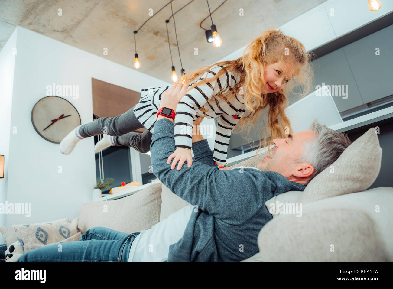 Cute small daughter with long hair feeling wonderful Stock Photo - Alamy