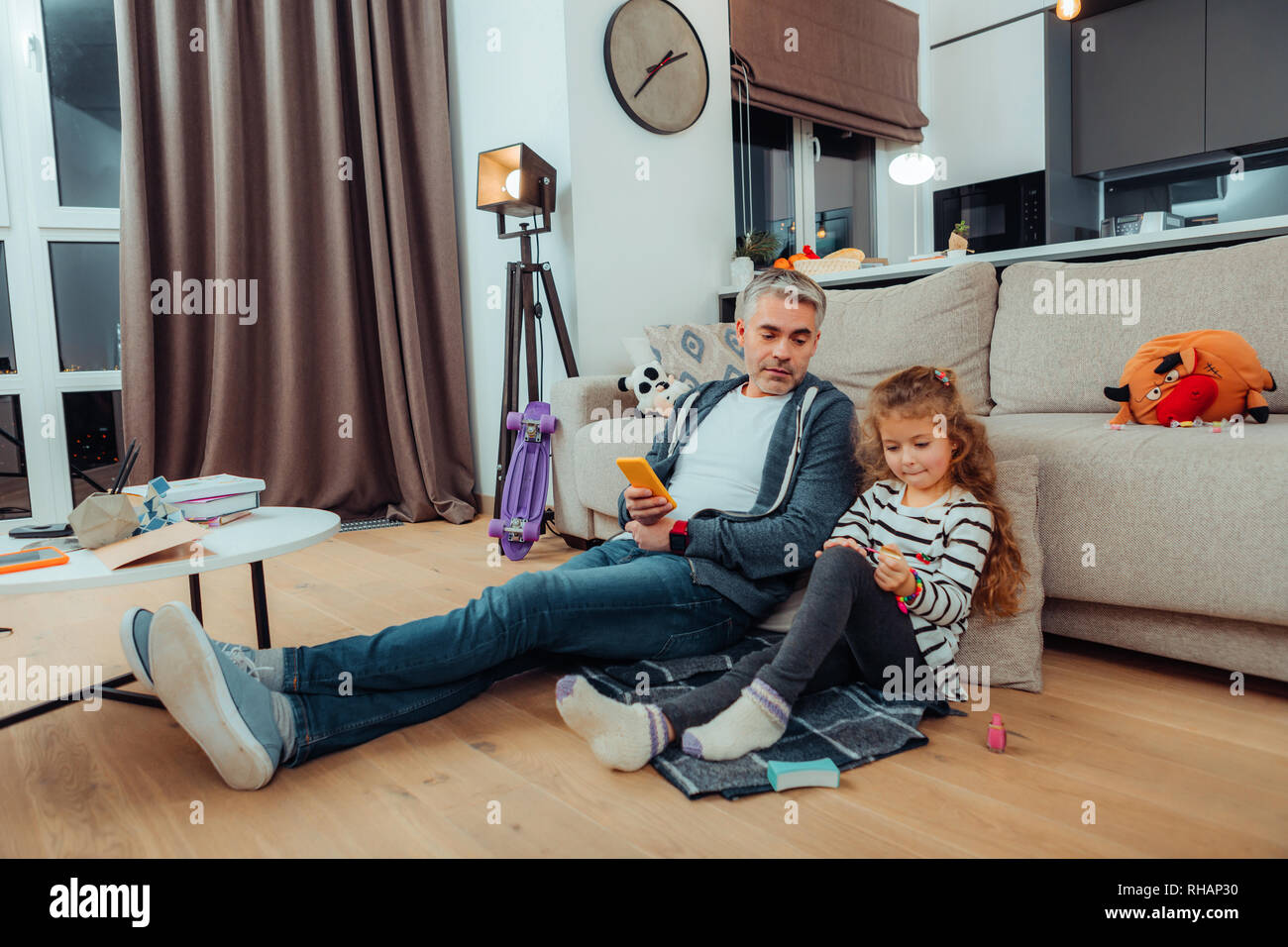 Tall handsome grey-haired father in sportswear looking amused Stock ...