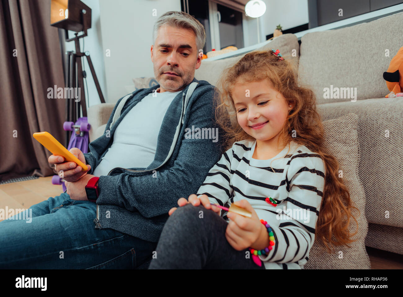 Tall handsome grey-haired father in sportswear looking thoughtful Stock ...