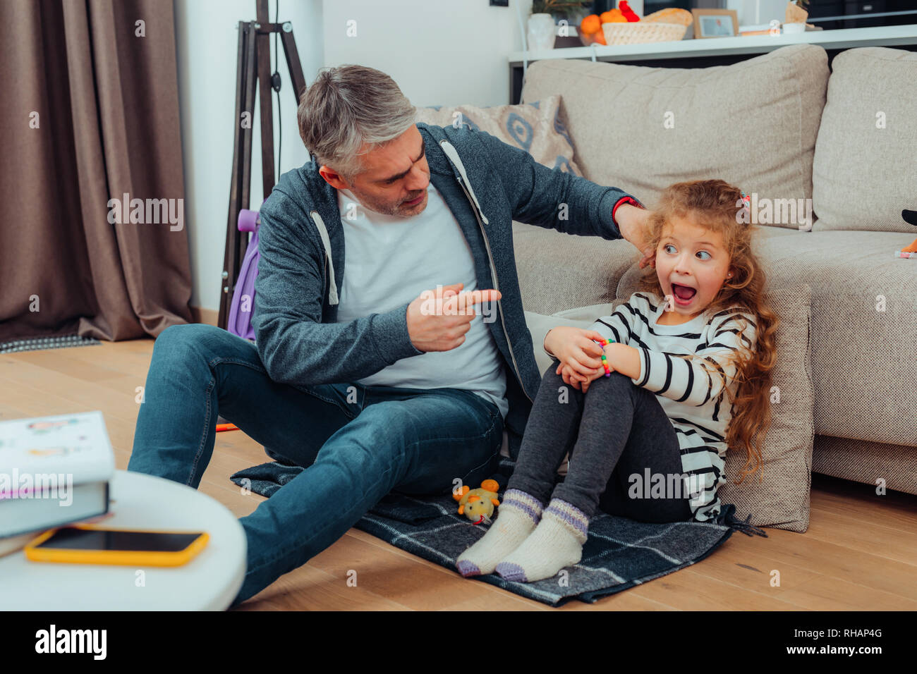 Handsome grey-haired tall father with a red watch feeling angry Stock ...