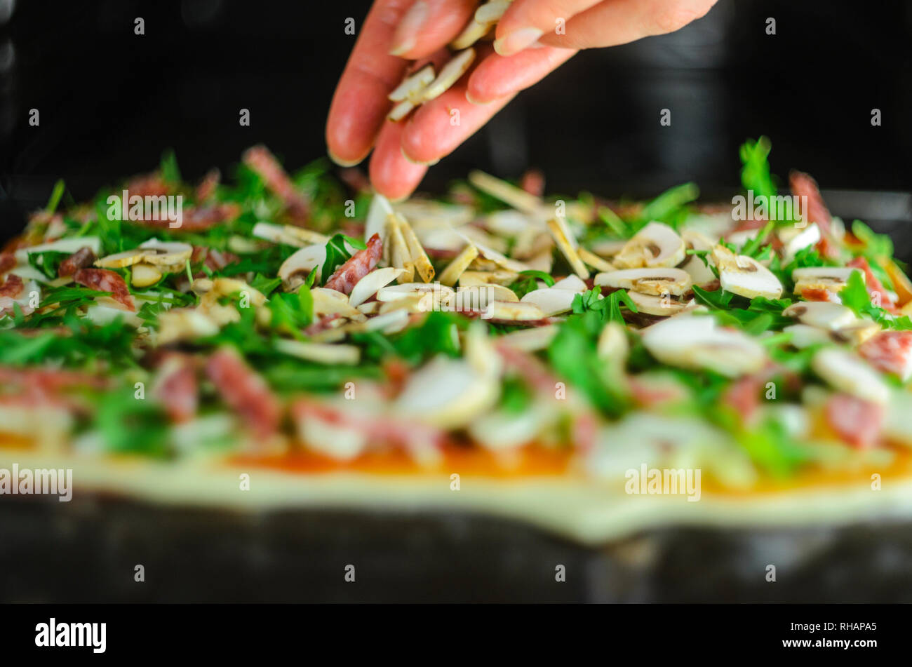 Process of making pizza. Italian pepperoni pizza with mushrooms ...