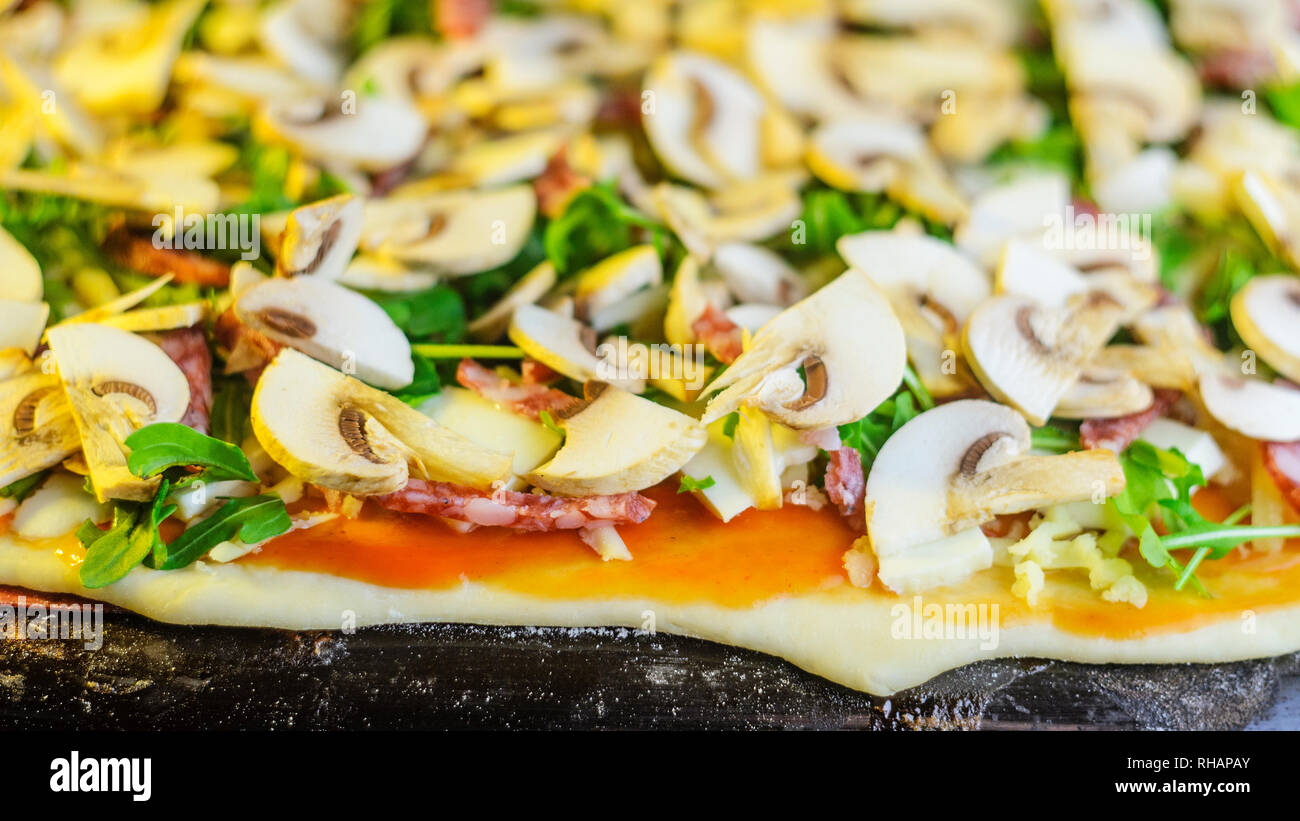 Process of making pizza. Italian pepperoni pizza with mushrooms ...