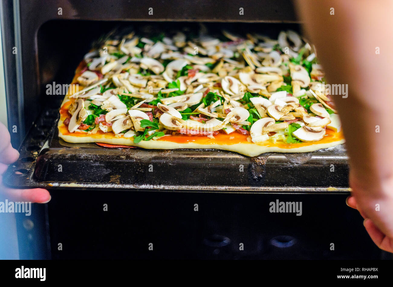 Process of making pizza. Italian pepperoni pizza with mushrooms ...