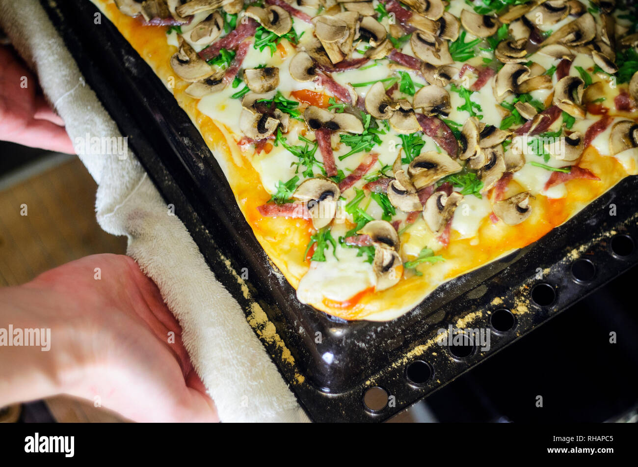 Process of making pizza. Italian pepperoni pizza with mushrooms ...