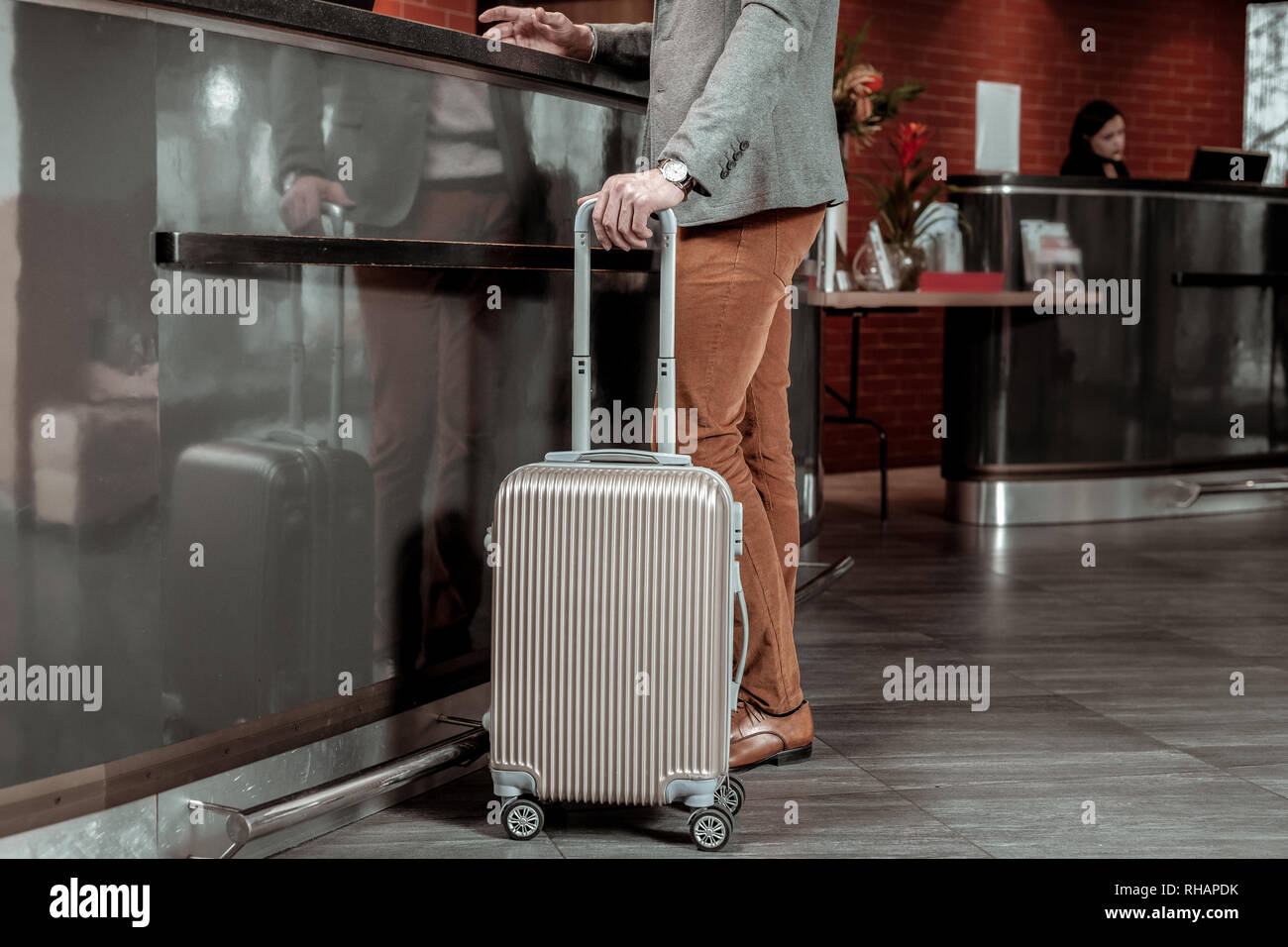 Young businessman putting his hand on luggage Stock Photo - Alamy