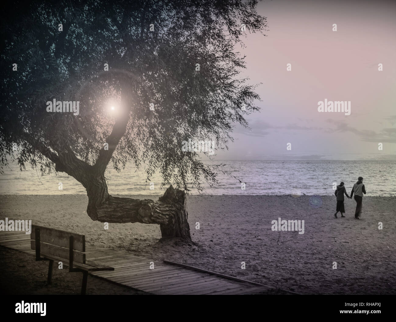 A young couple walks on the beach at Lake Huron in Goderich, Ontario ...