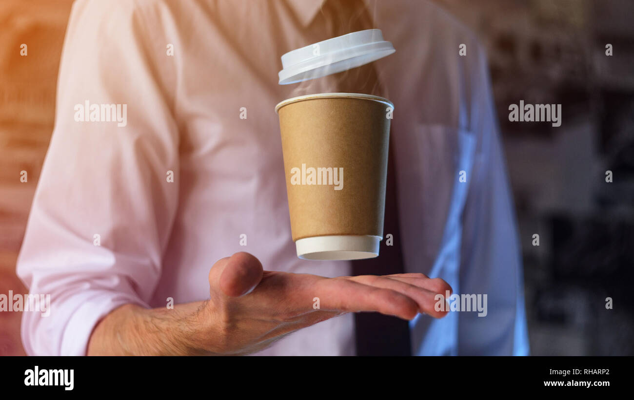 Barista in a white shirt with a tie holds floating in the air a paper ...