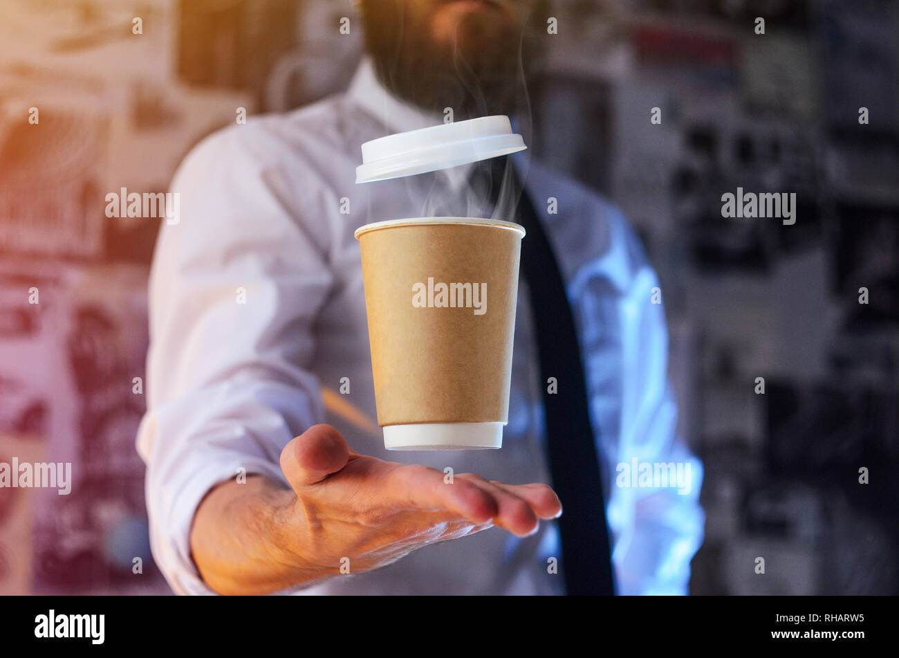 Barista in a white shirt with a tie holds floating in the air a paper ...