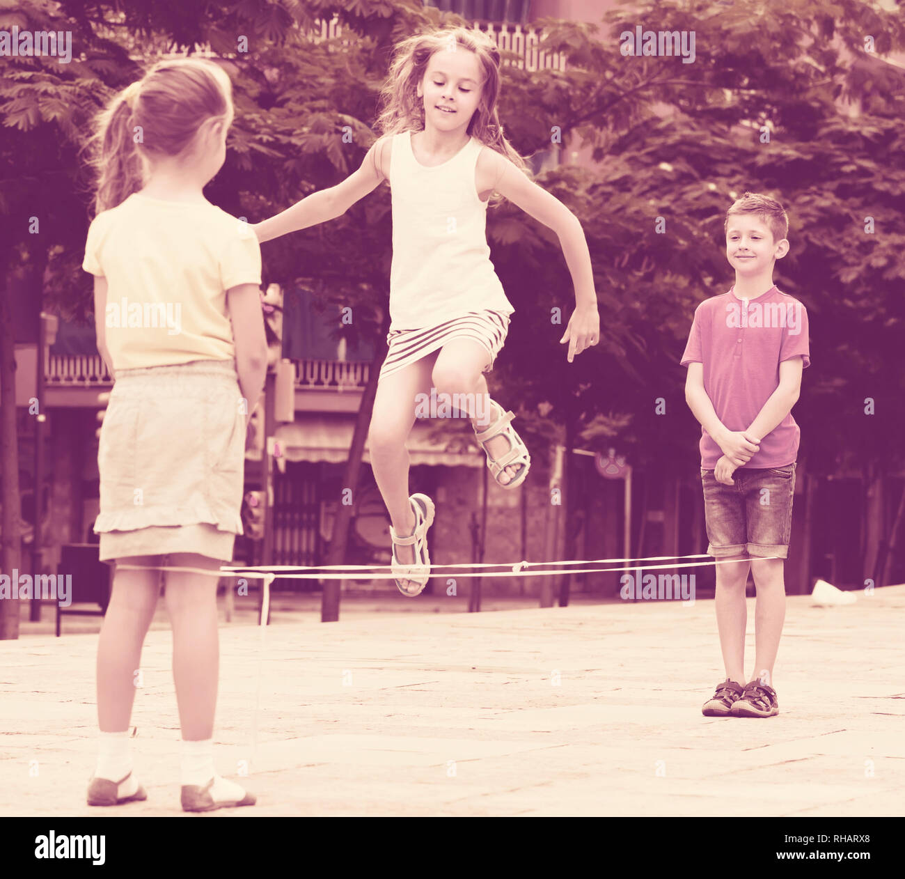 joyful smiling boy and girls in elementary school age playing with ...