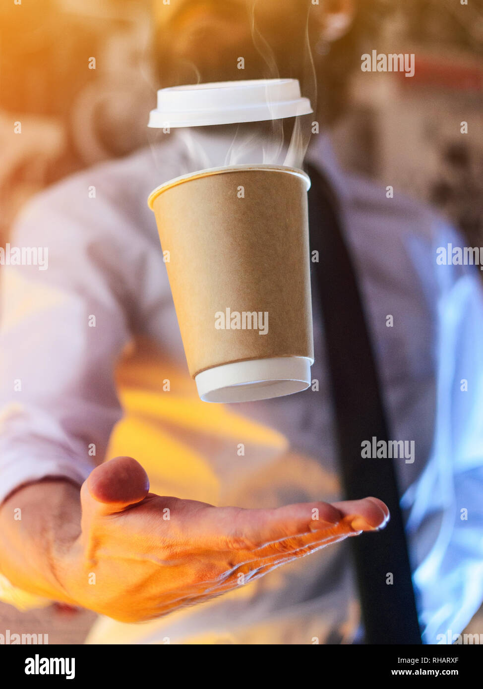 Barista in a white shirt with a tie holds floating in the air a paper ...