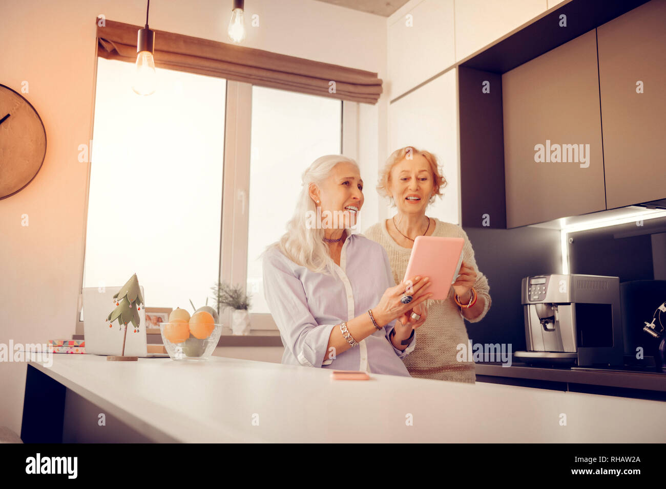Joyful aged women using a modern tablet Stock Photo - Alamy