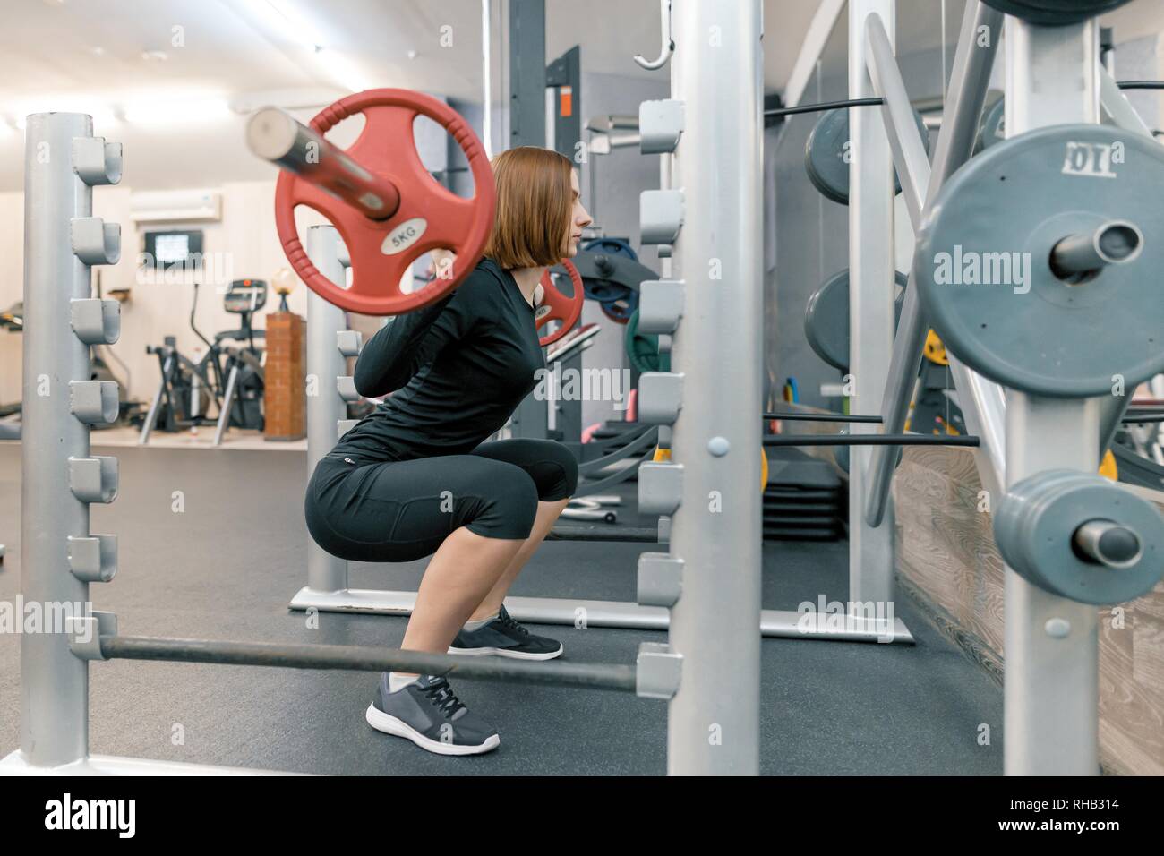 Strong young woman doing heavy weight workout in gym. Sport, fitness ...