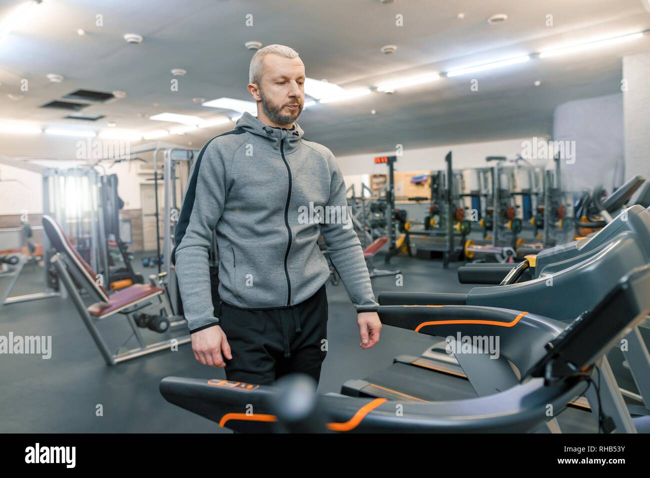 Adult handsome bearded man doing physical exercises in the gym. Sport ...