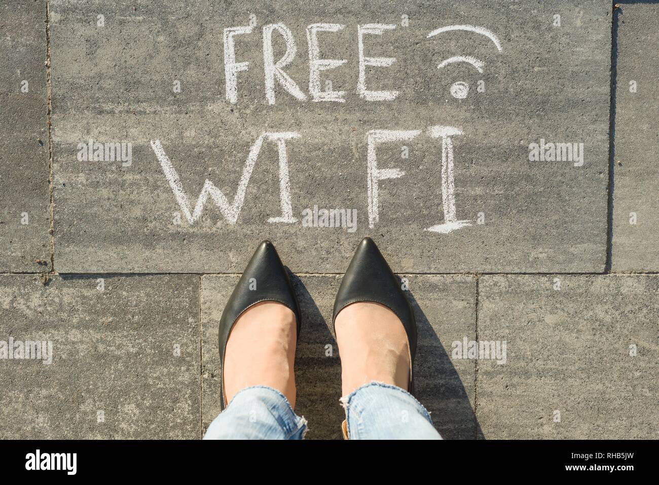 Female feet with text free wi fi written on grey sidewalk Stock Photo ...