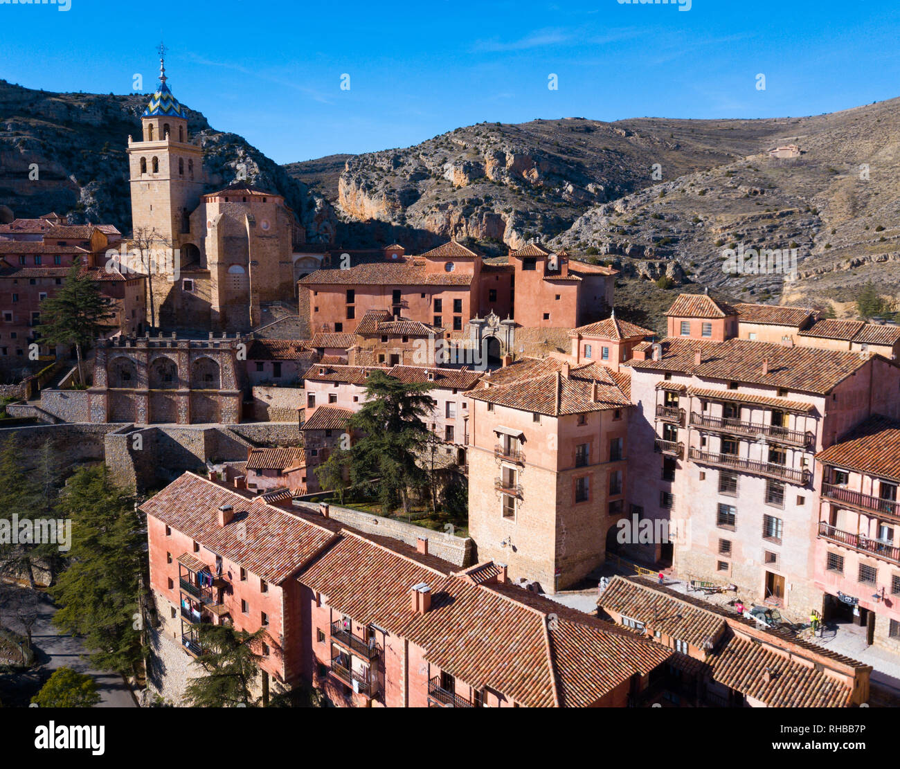 Aerial view of tiled housetops and defensive wall of medieval town ...