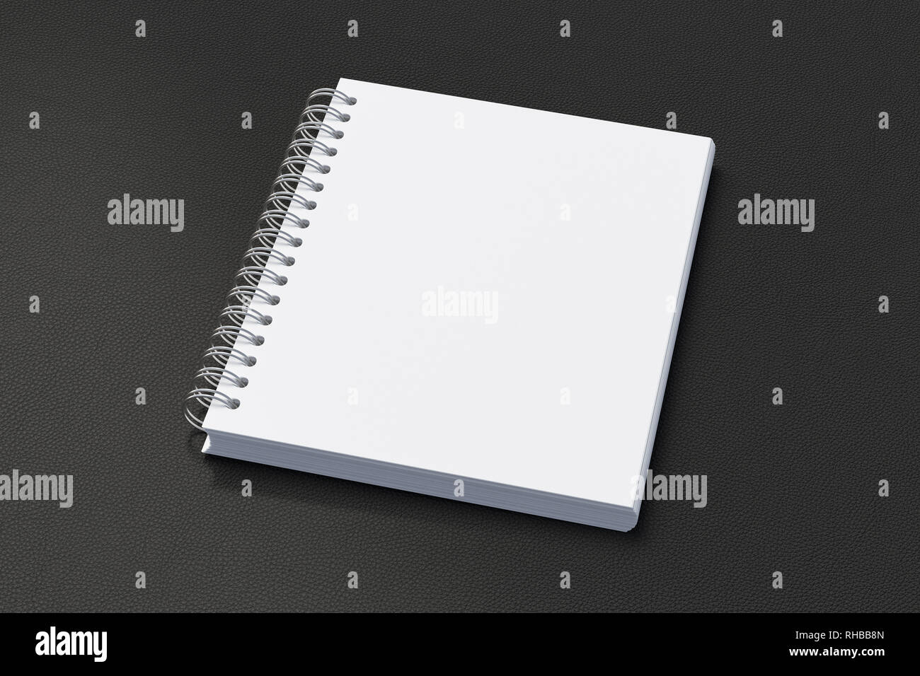 Blank vertical spiral notepad on black background. With clipping path ...