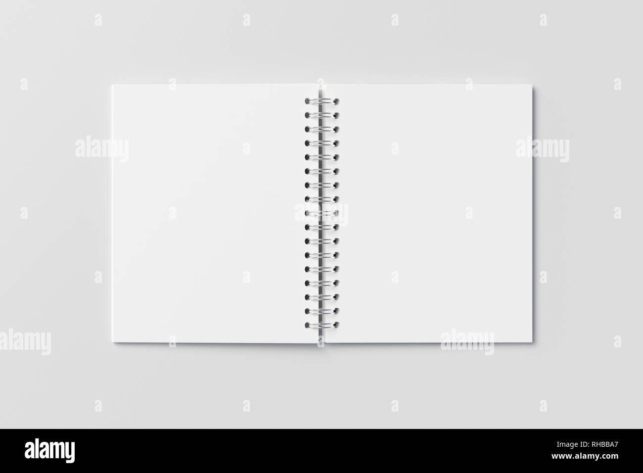 Blank open vertical spiral notepad on white background. With clipping ...