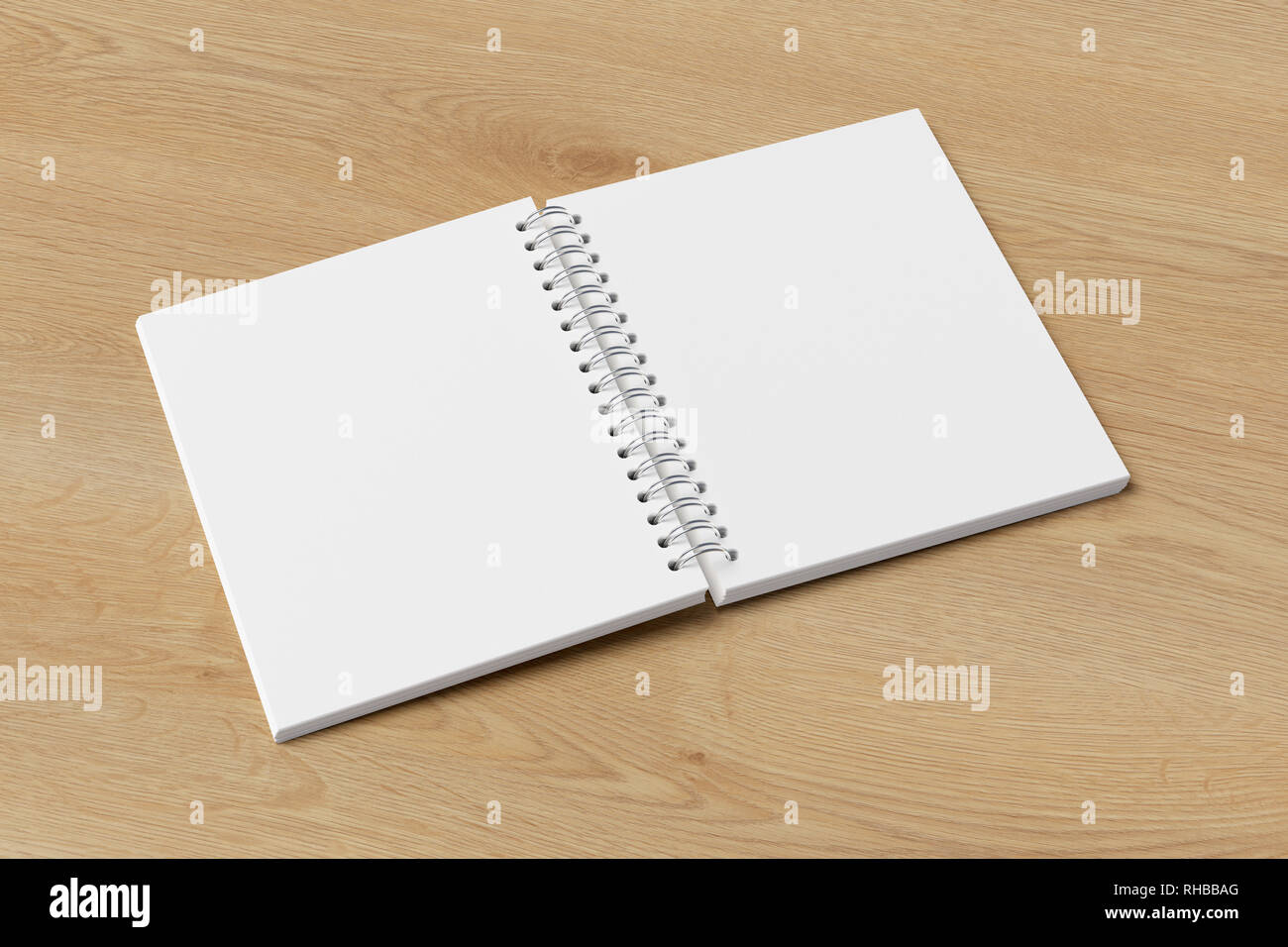 Blank open vertical spiral notepad on wooden background. With clipping ...