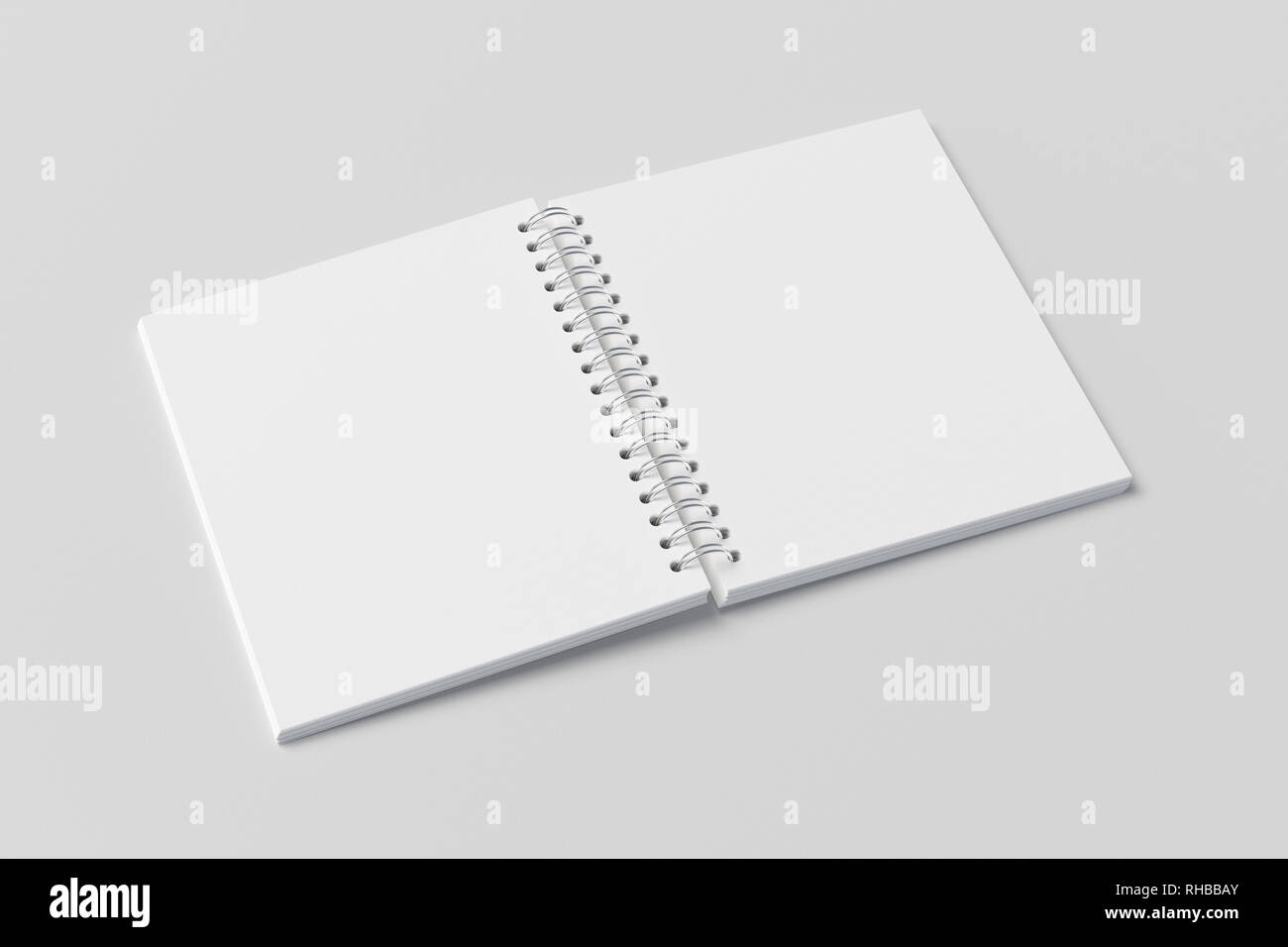 Blank open vertical spiral notepad on white background. With clipping ...