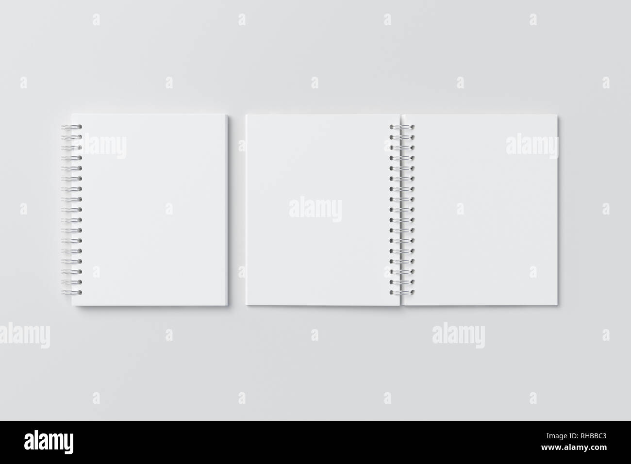 Blank open and closed vertical spiral notepads on white background ...